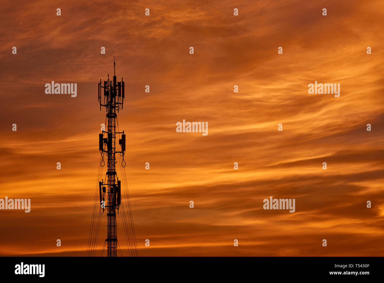 Silhouette signal antenna tower at beautiful sunrise sky background ...