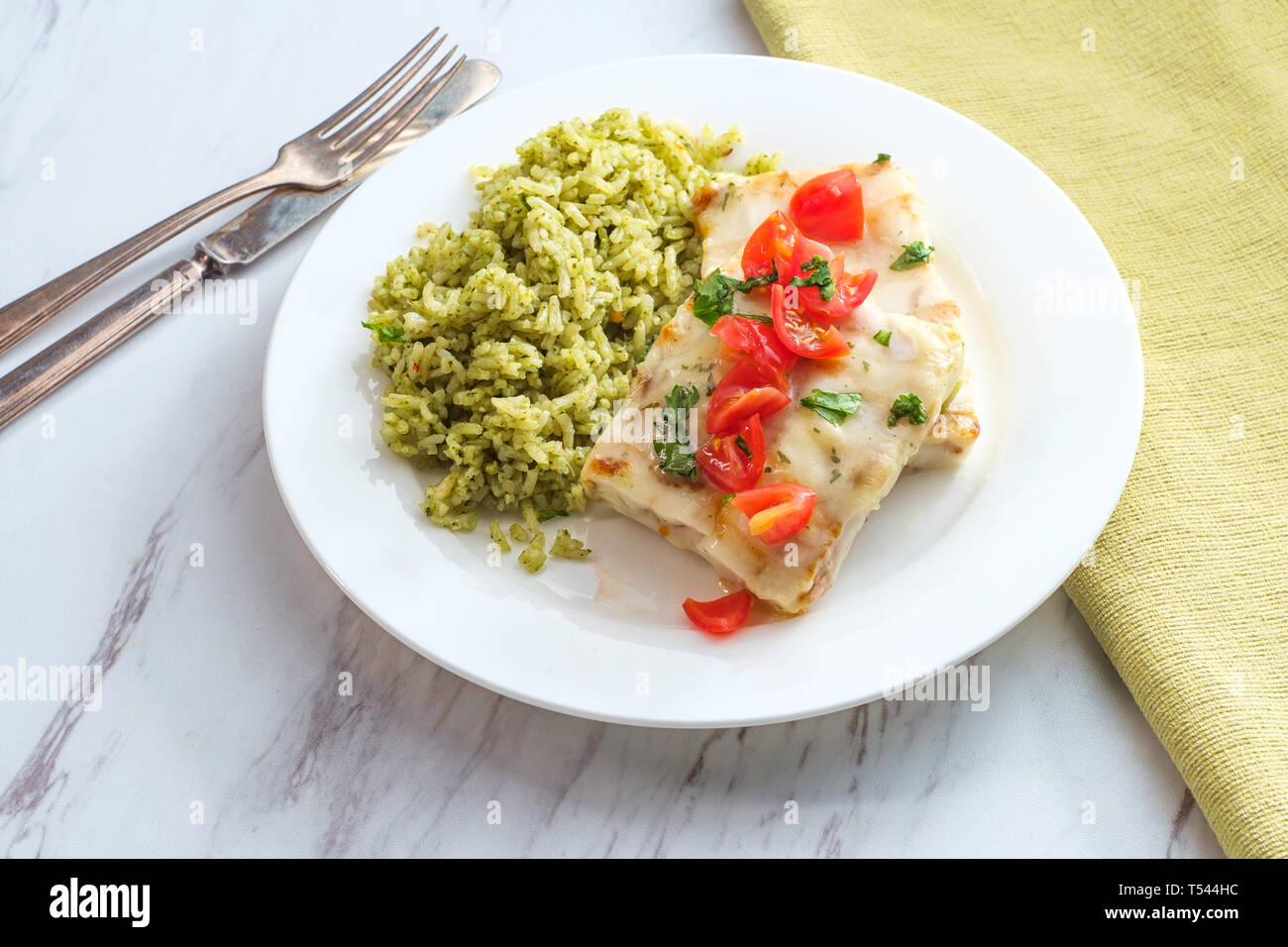 Grilled Alaskan Pollock fish fillets with lemon butter and green rice ...
