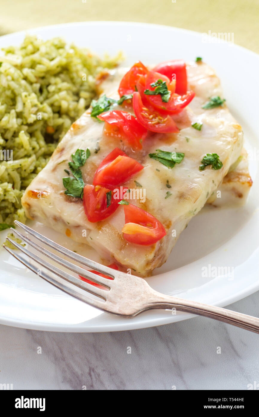 Grilled Alaskan Pollock fish fillets with lemon butter and green rice ...