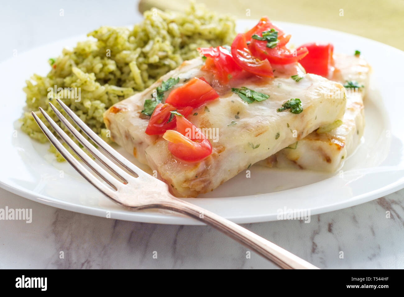 Grilled Alaskan Pollock fish fillets with lemon butter and green rice ...