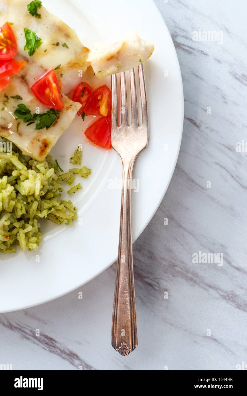 Grilled Alaskan Pollock fish fillets with lemon butter and green rice ...
