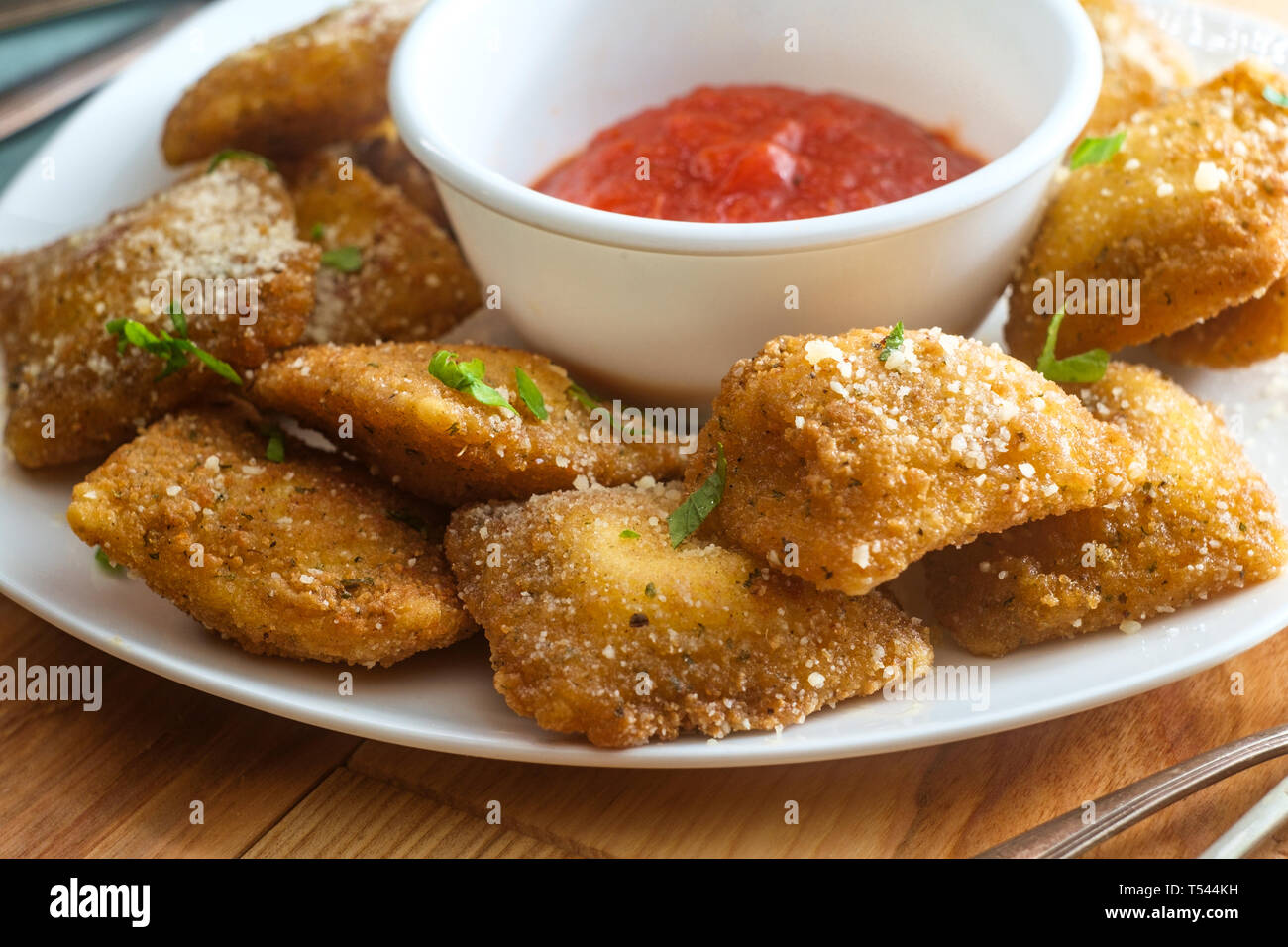 Breaded fried Italian ravioli with hot marinara tomato dipping sauce ...