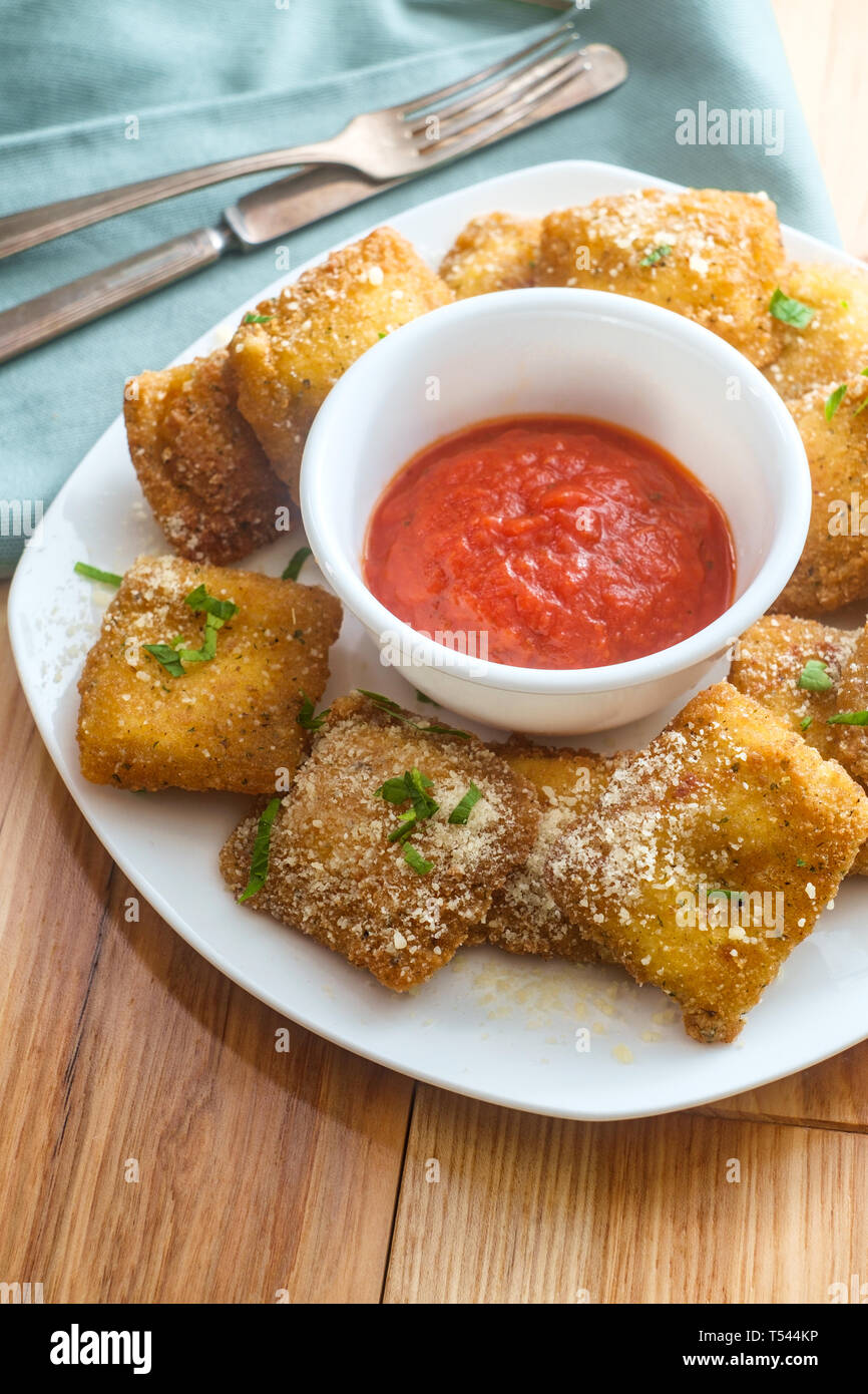 Breaded fried Italian ravioli with hot marinara tomato dipping sauce ...