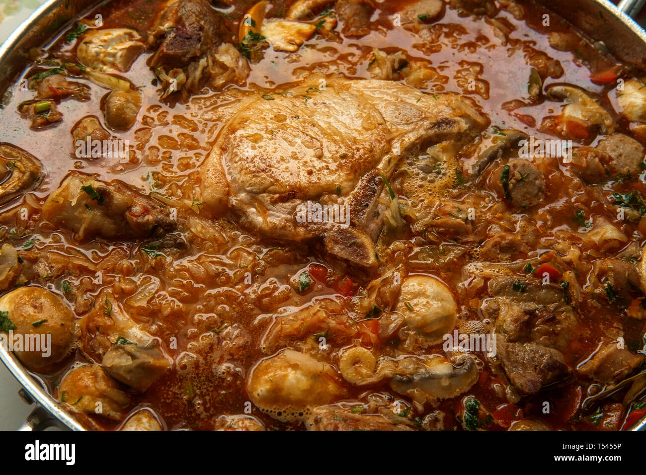 Polish hunters stew known as Bigos with pork loin sausage and lamb neck ...