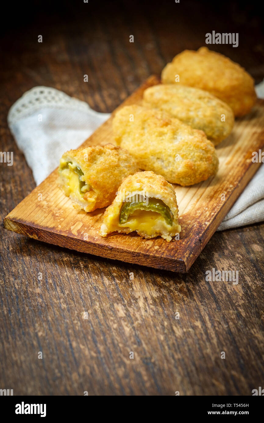 Crispy fried cheddar cheese jalapeno popper bites served on wooden ...