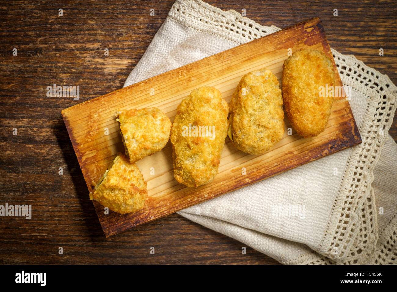 Crispy fried cheddar cheese jalapeno popper bites served on wooden ...