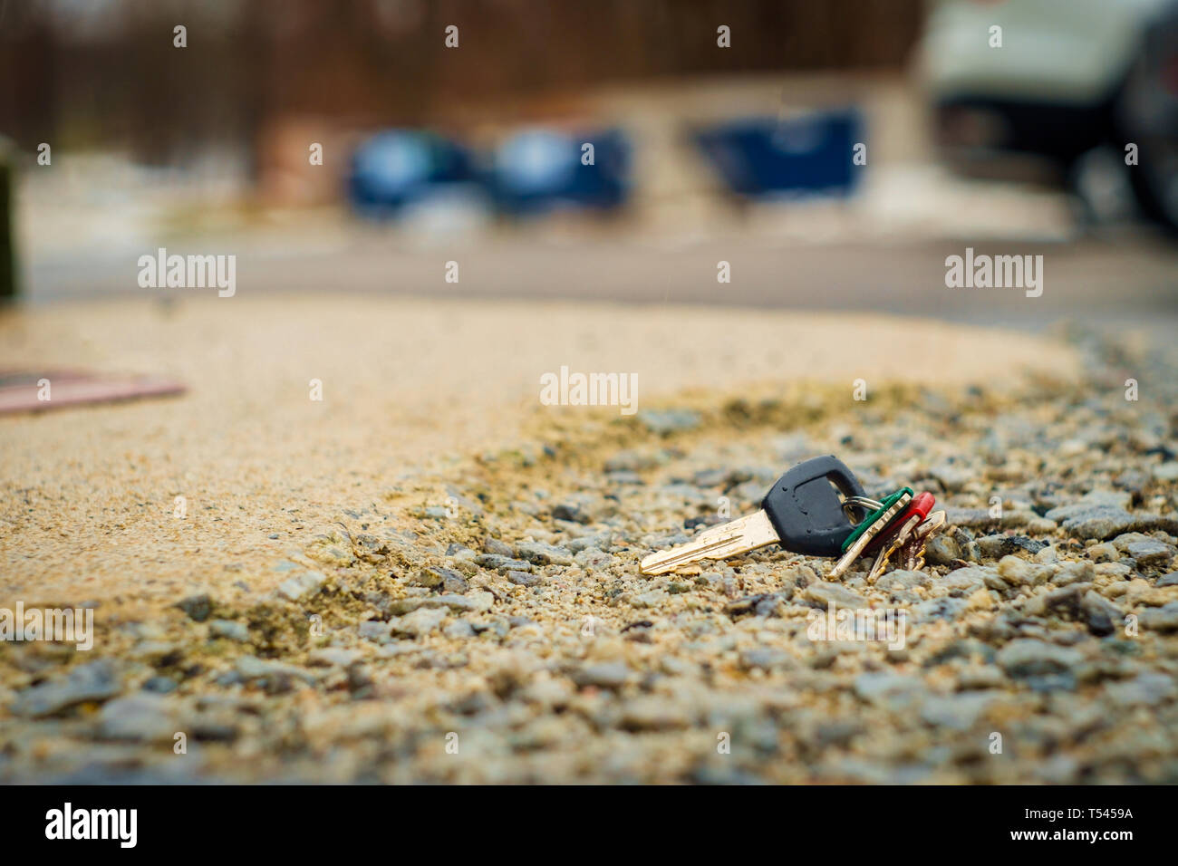Rainy day lost car keys in wet parking lot pavement Stock Photo - Alamy