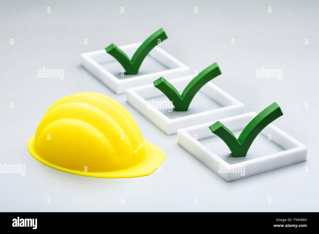 Yellow Hard Hat With Green Checklist Isolated On White Background Stock ...