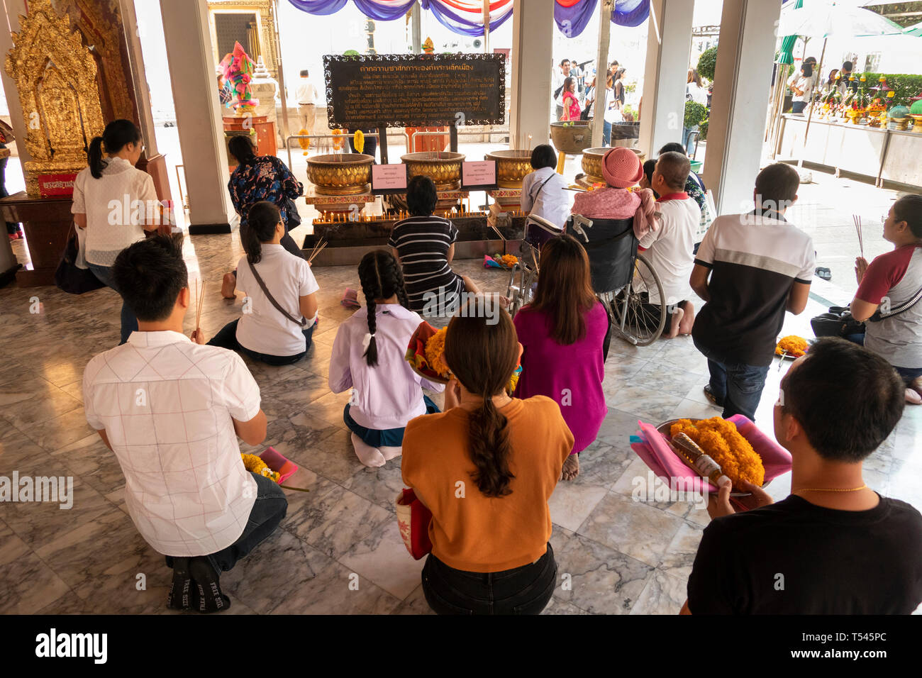 Thailand, Bangkok, Lak Muuang, City Pillar Shrine, worshippers kneeling ...