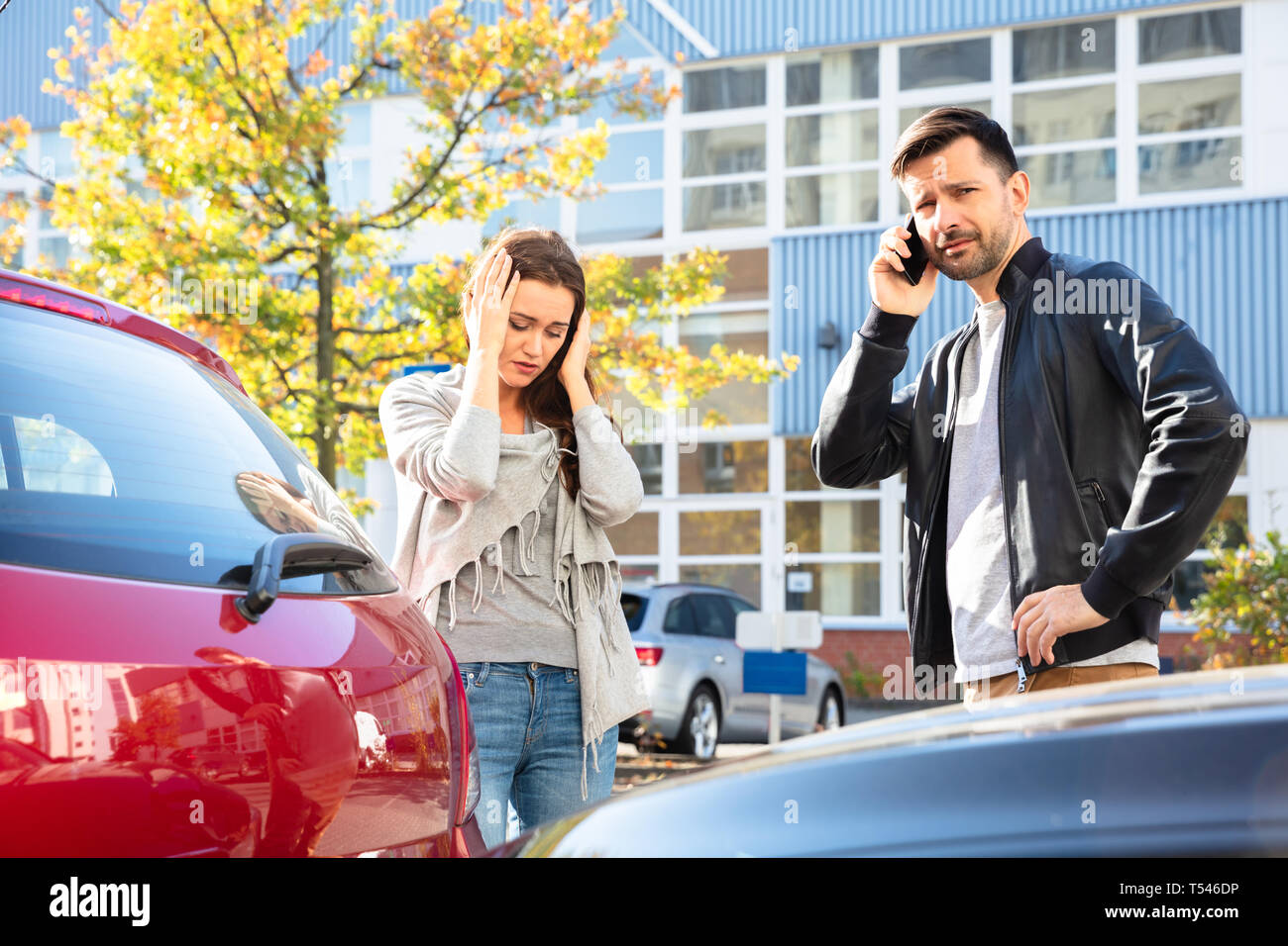 Man Calling For Assistance In Front Of Sad Woman Looking Damaged Car On ...