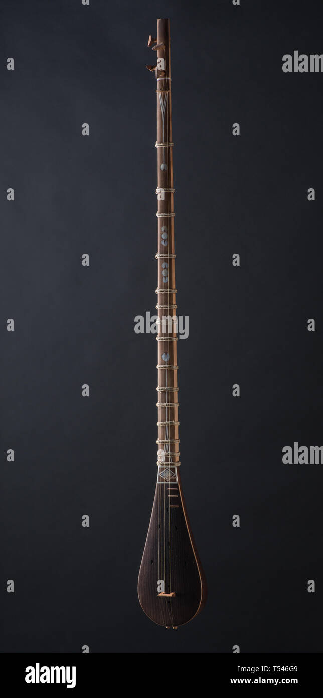 ancient Asian stringed musical instrument on black background with ...