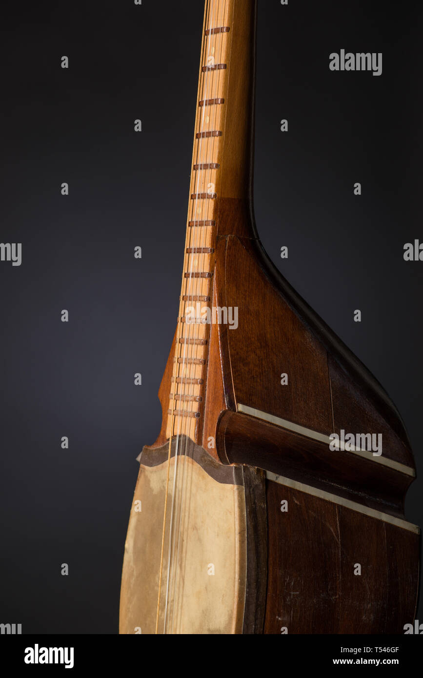 part ancient Asian stringed musical instrument on black background with ...