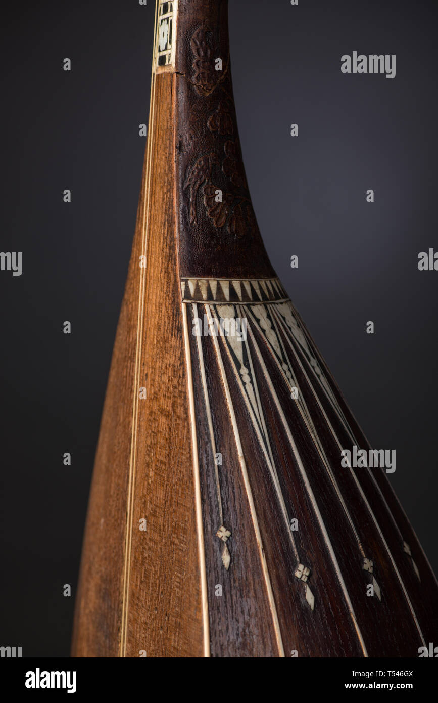 part ancient Asian stringed musical instrument on black background with ...