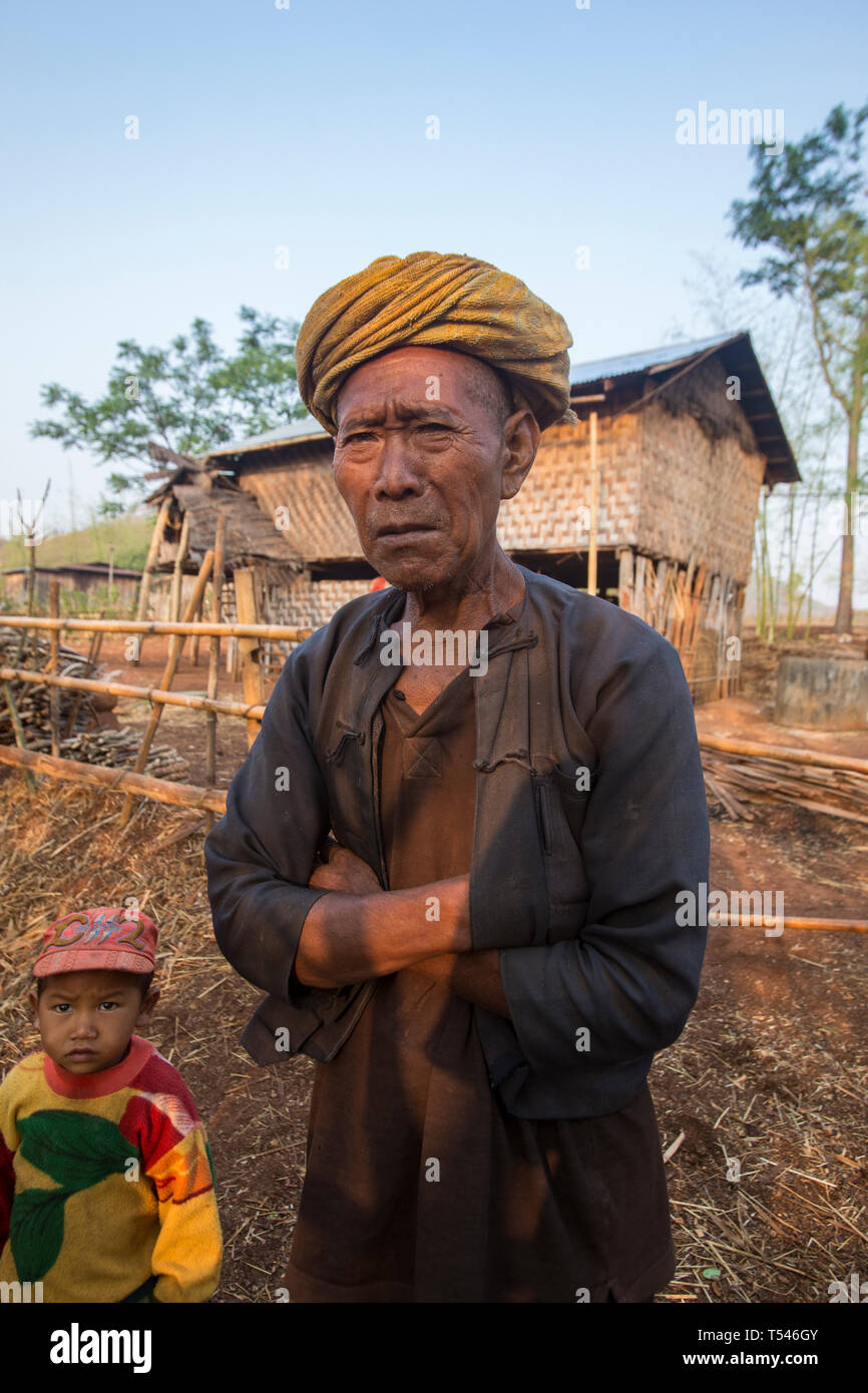 Elderly Shan man with his grandson in a hill village on the trek from ...