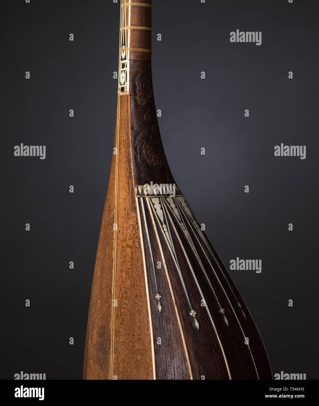 part ancient Asian stringed musical instrument on black background with ...