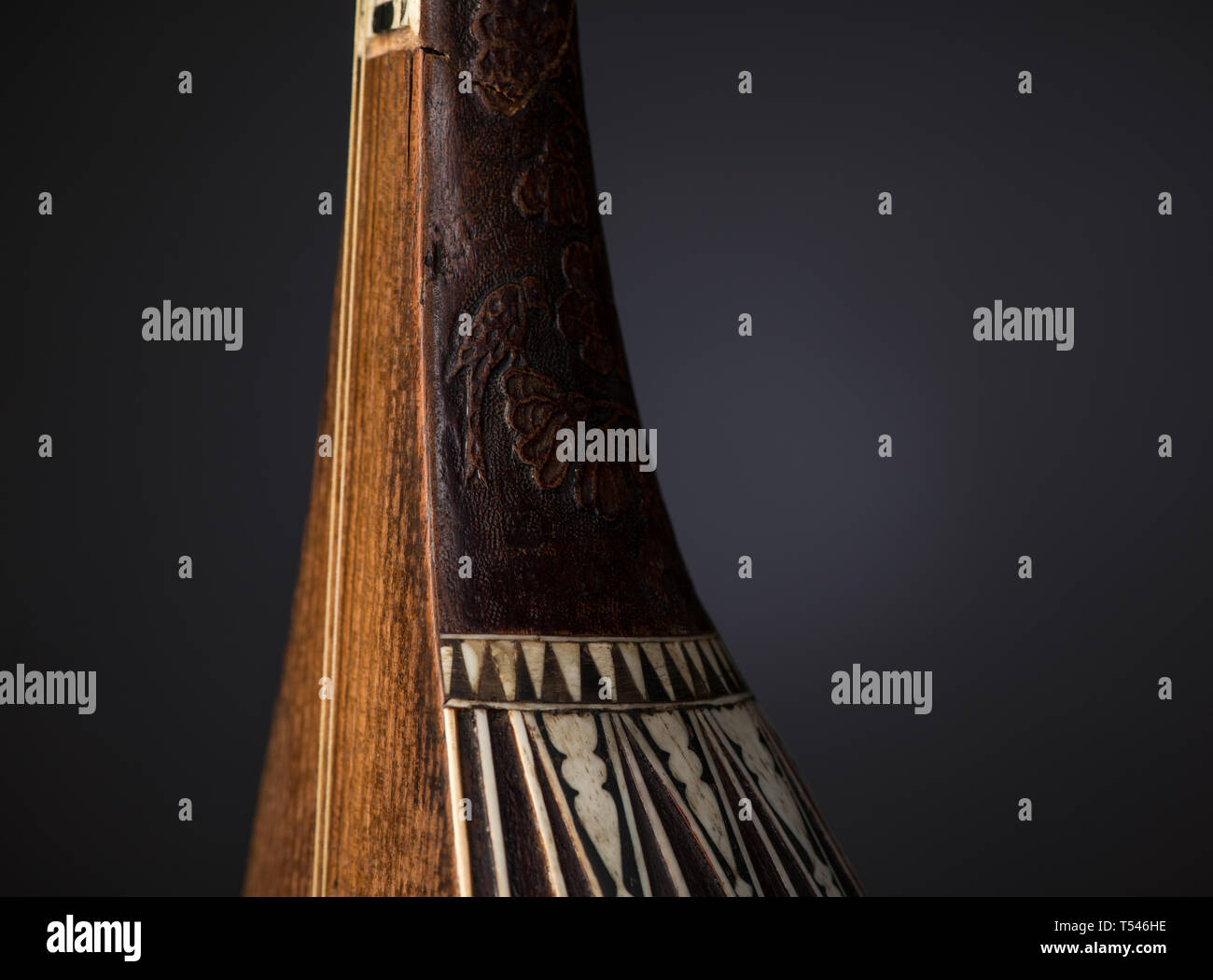 part ancient Asian stringed musical instrument on black background with ...