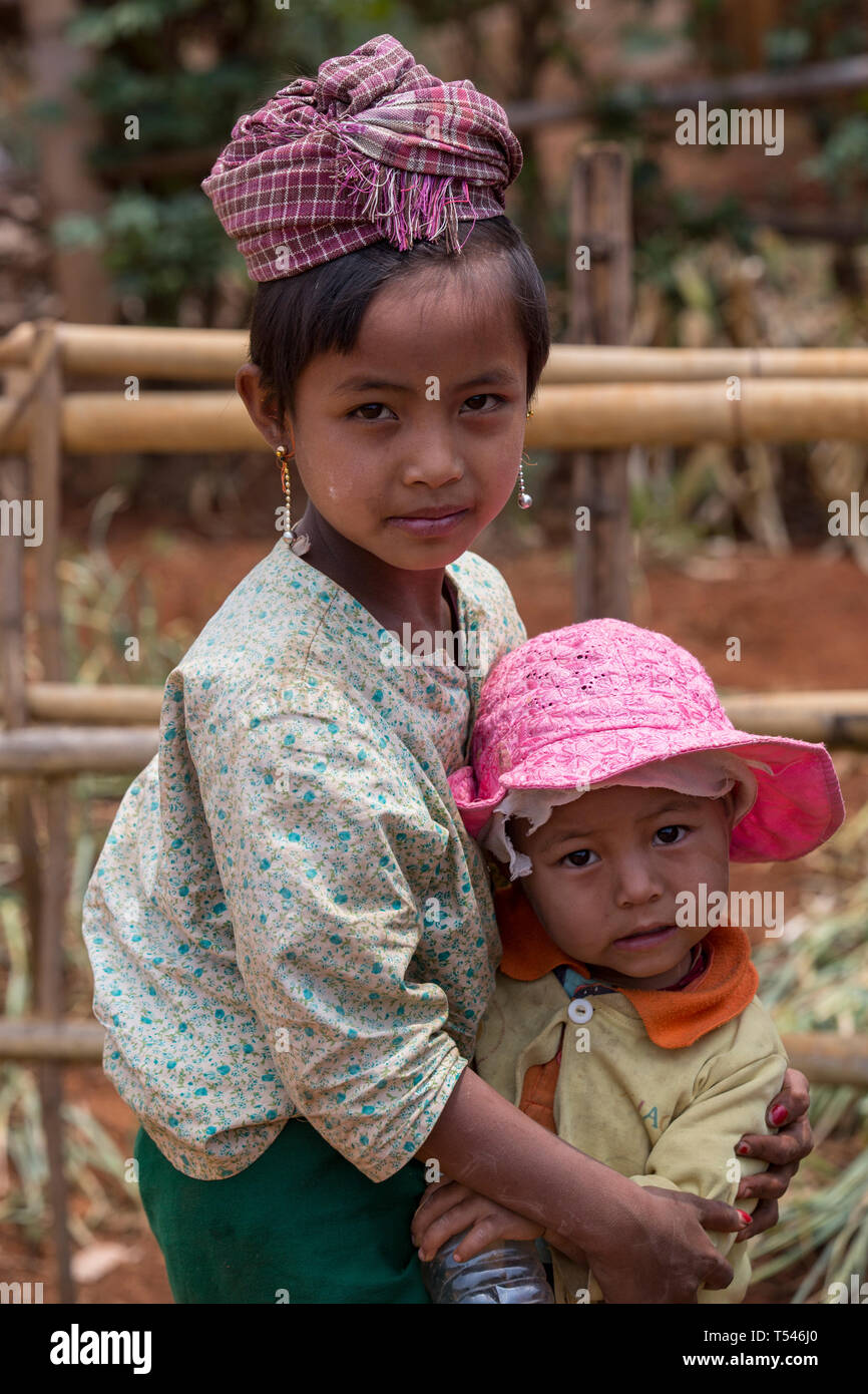 Young Shan girl with her little brother in a village on the trek from ...