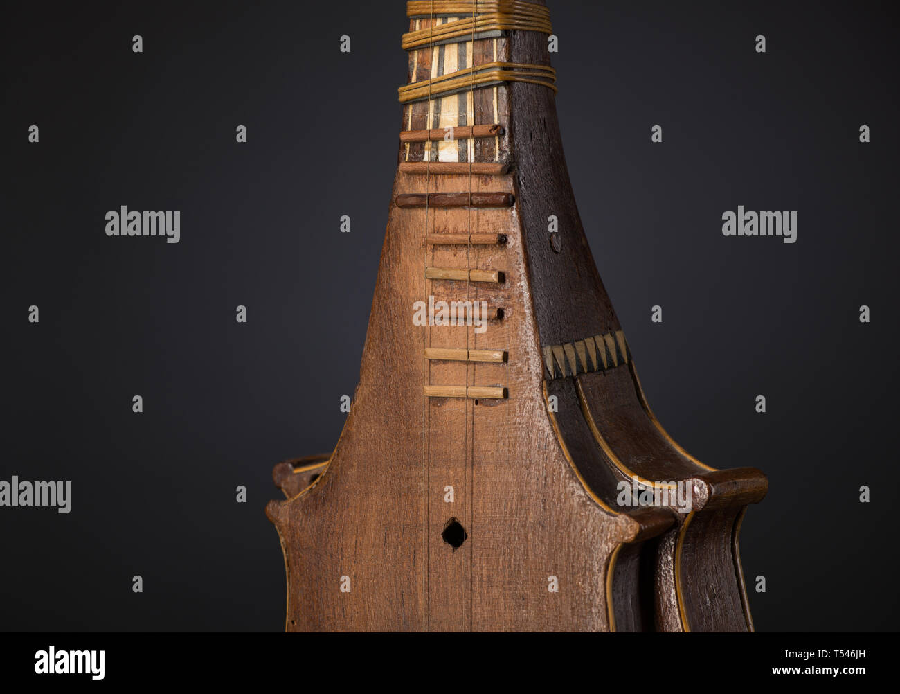 part ancient Asian stringed musical instrument on black background with ...