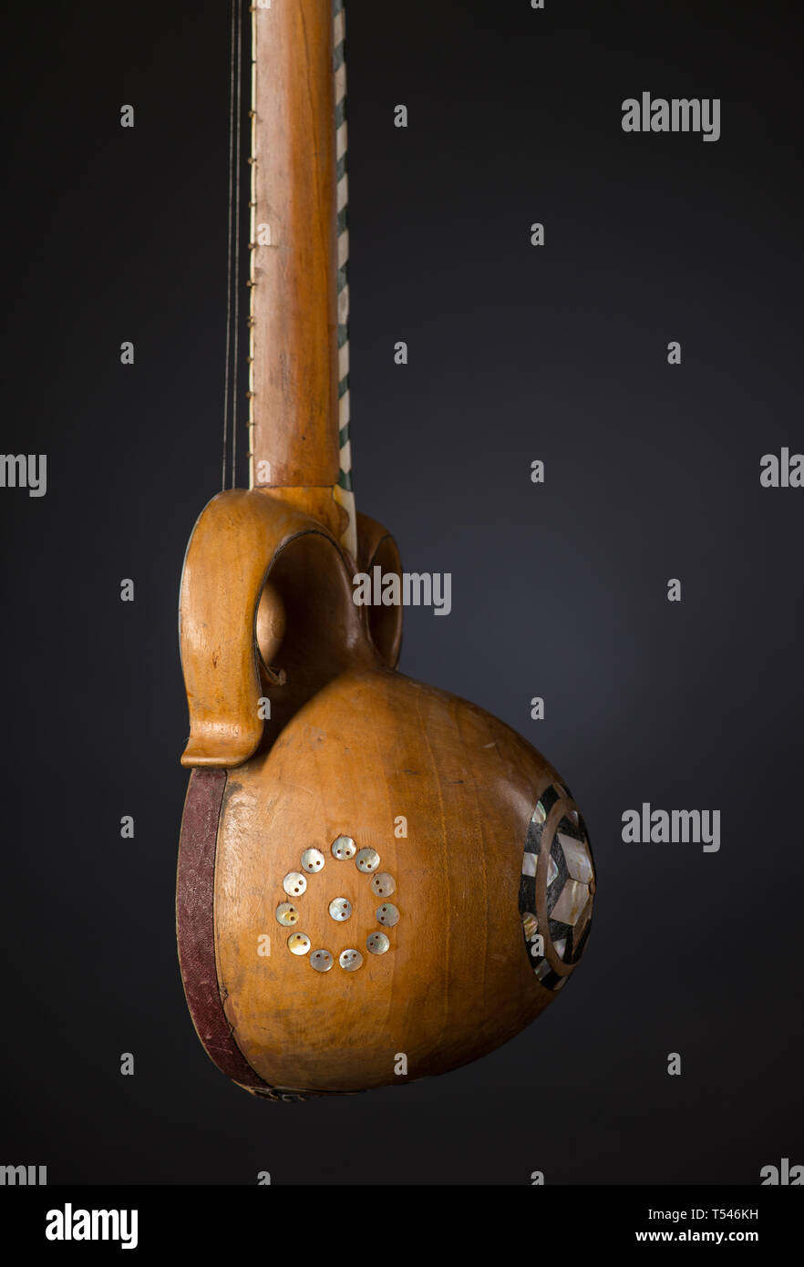 part ancient Asian stringed musical instrument on black background with ...