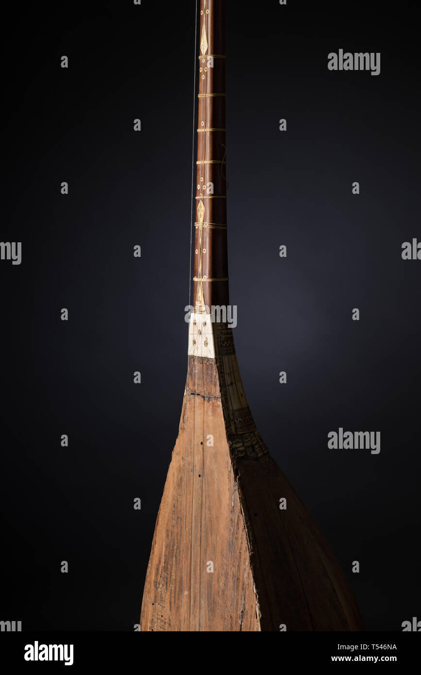 part ancient Asian stringed musical instrument on black background with ...