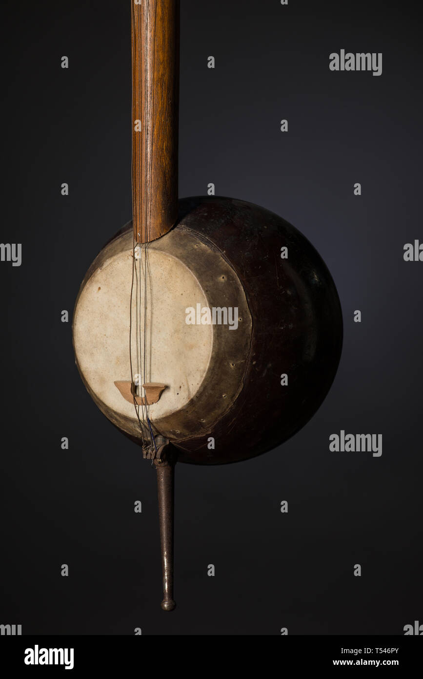 part ancient Asian stringed musical instrument on black background with ...