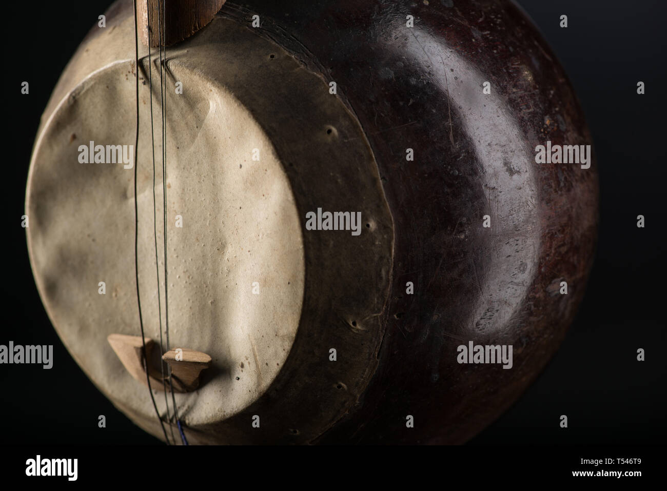 part ancient Asian stringed musical instrument on black background with ...