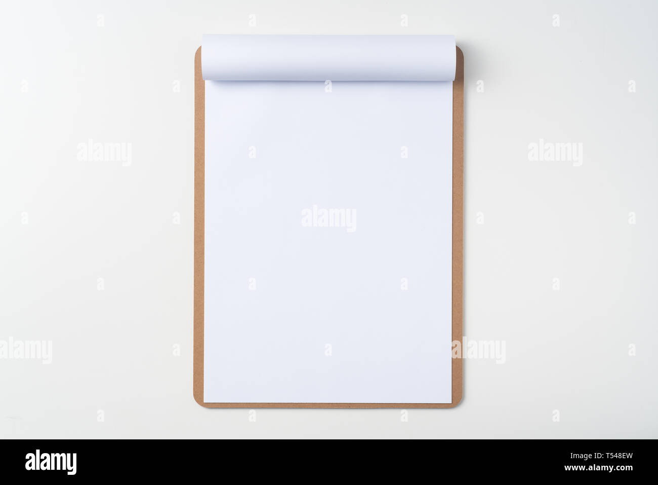 Design concept - top view of white A4 flipped paper on brown clipboard ...