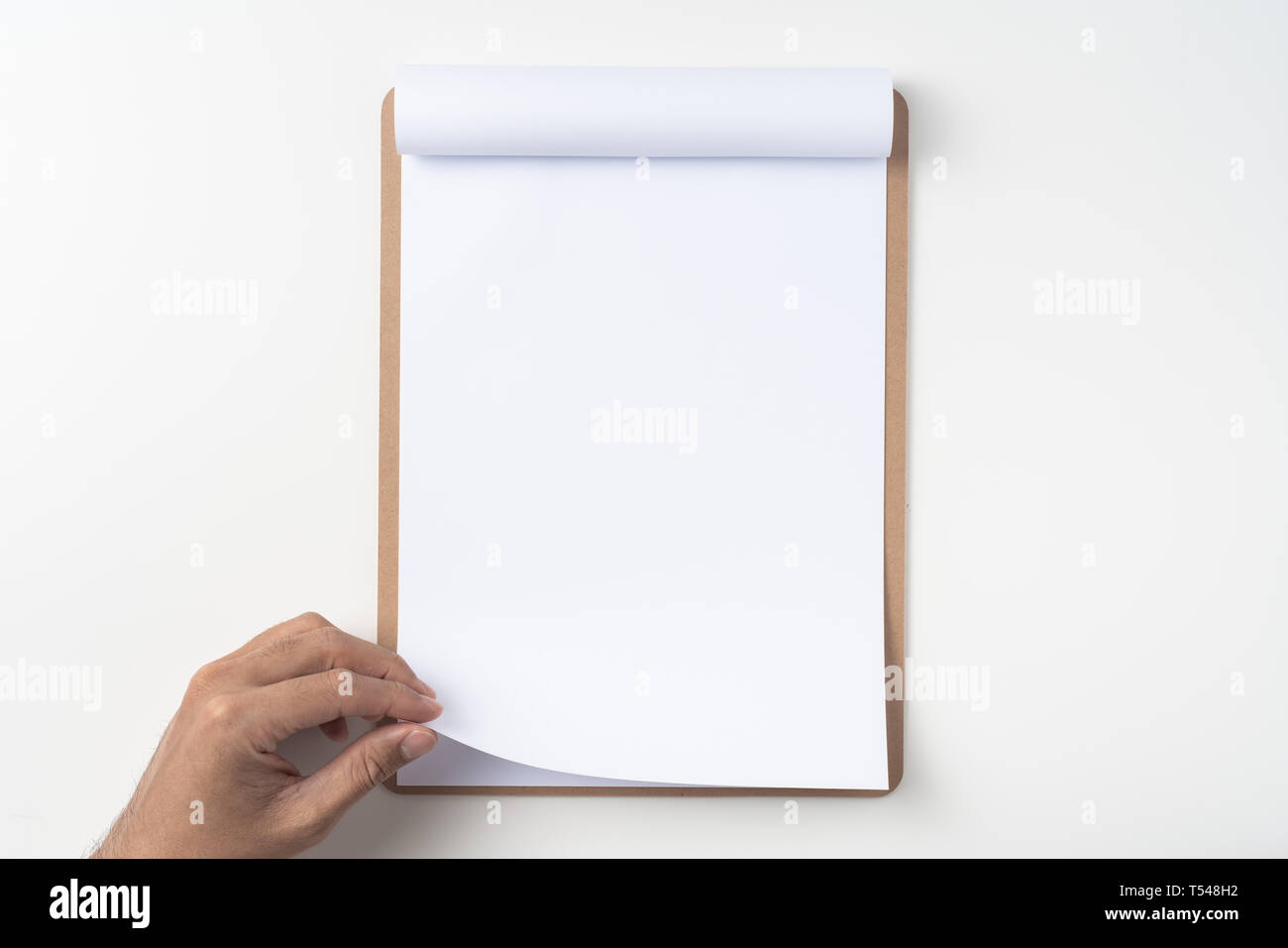 Design concept - top view of man hand hold white A4 flipped paper on ...