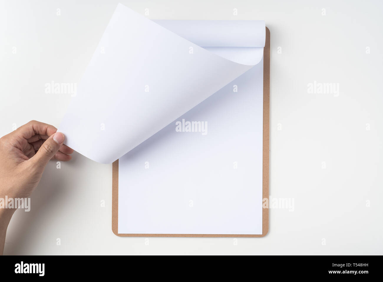 Design concept - top view of man hand hold white A4 flipped paper on ...