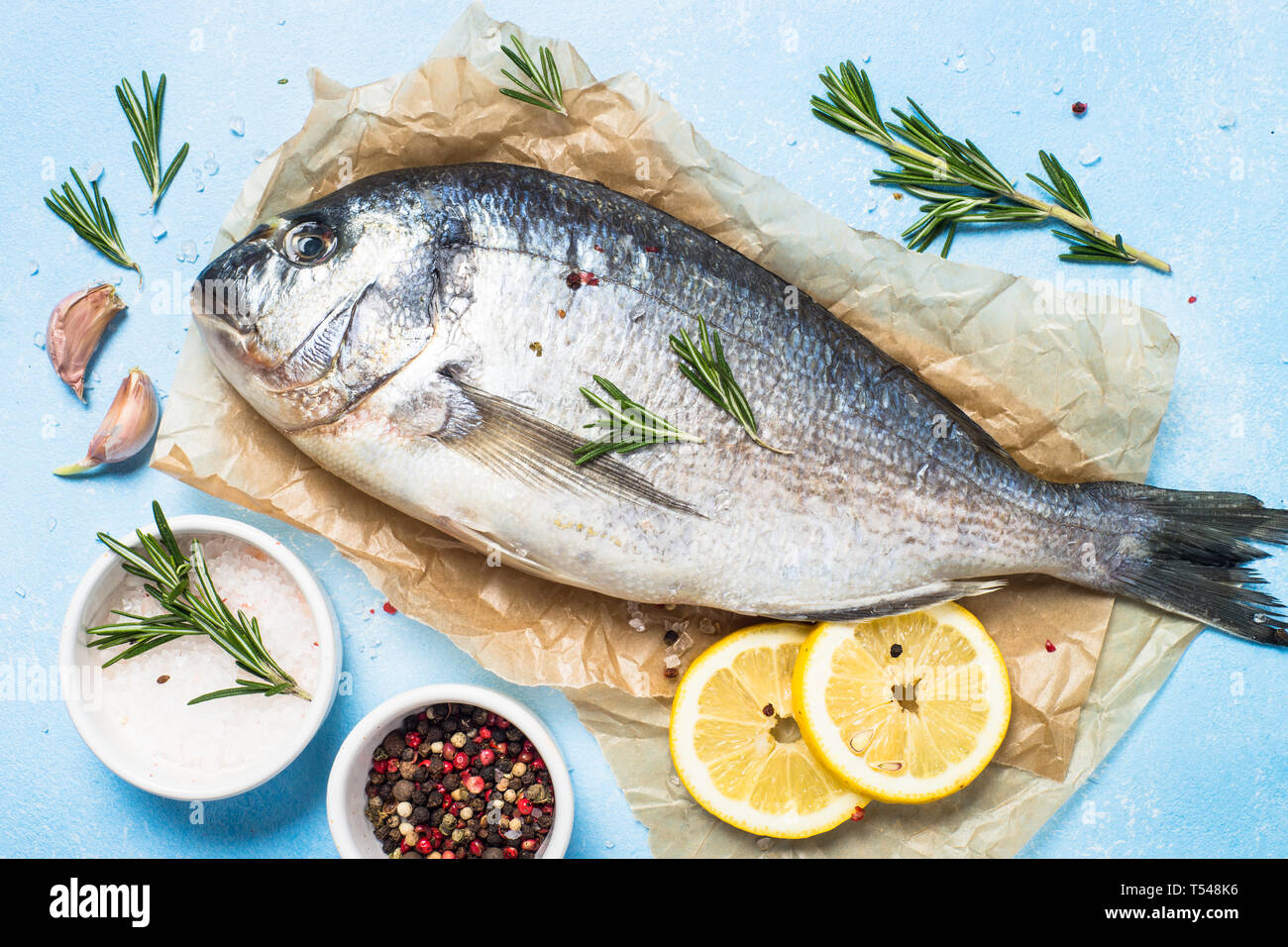 Fresh fish dorado on blue background Stock Photo - Alamy
