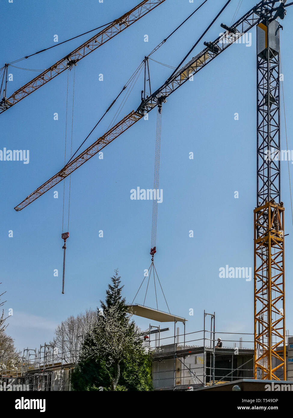 building crane on a building site lifting a pre-fabricated section ...