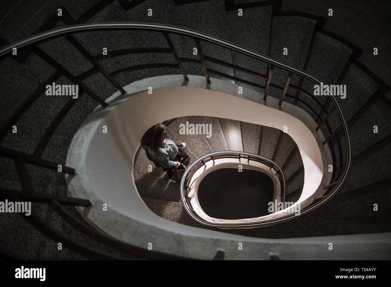 Woman climbing down steps hi-res stock photography and images - Alamy