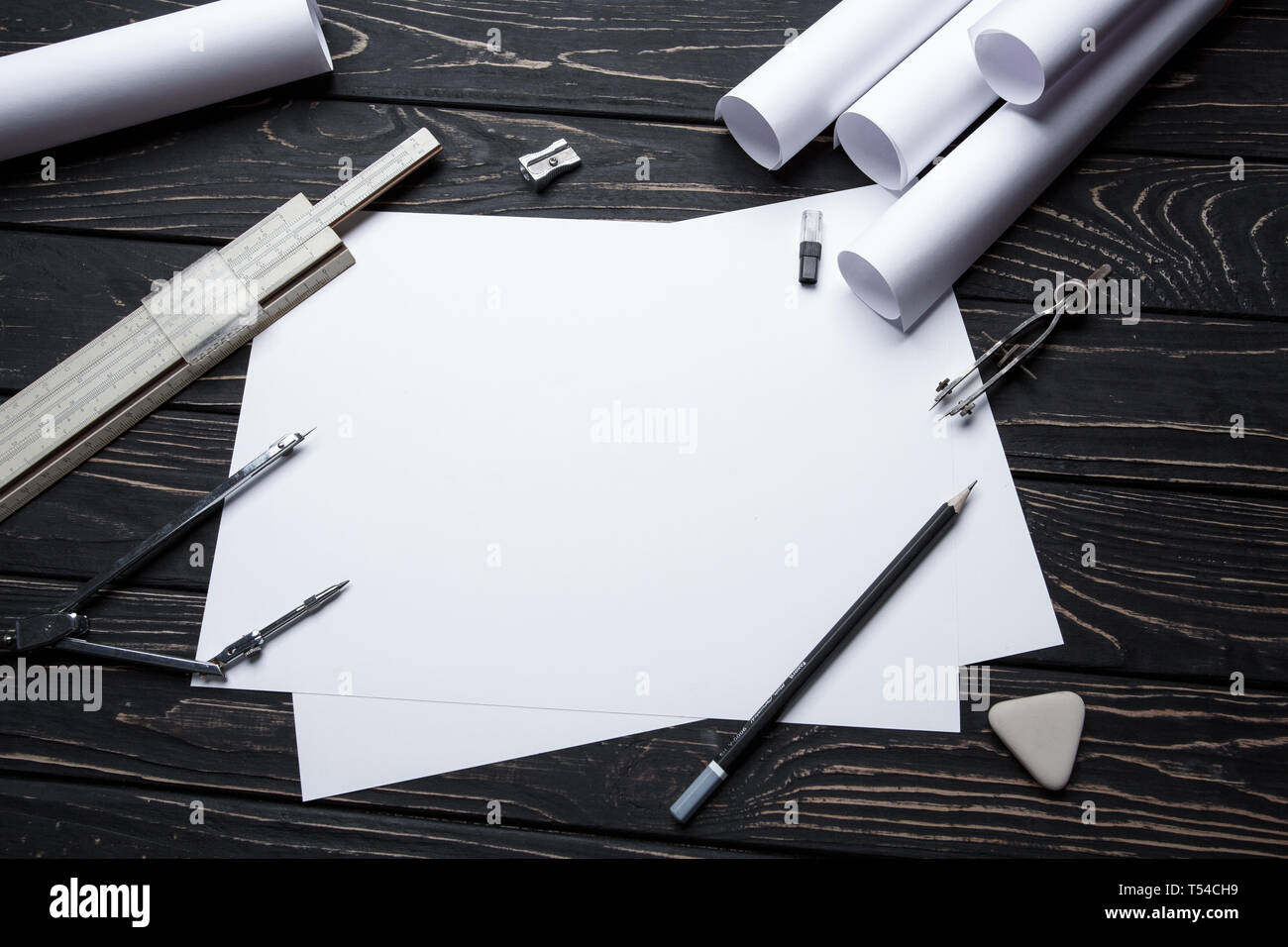 Work with the drawing. On the black wooden desk are tools for creating ...