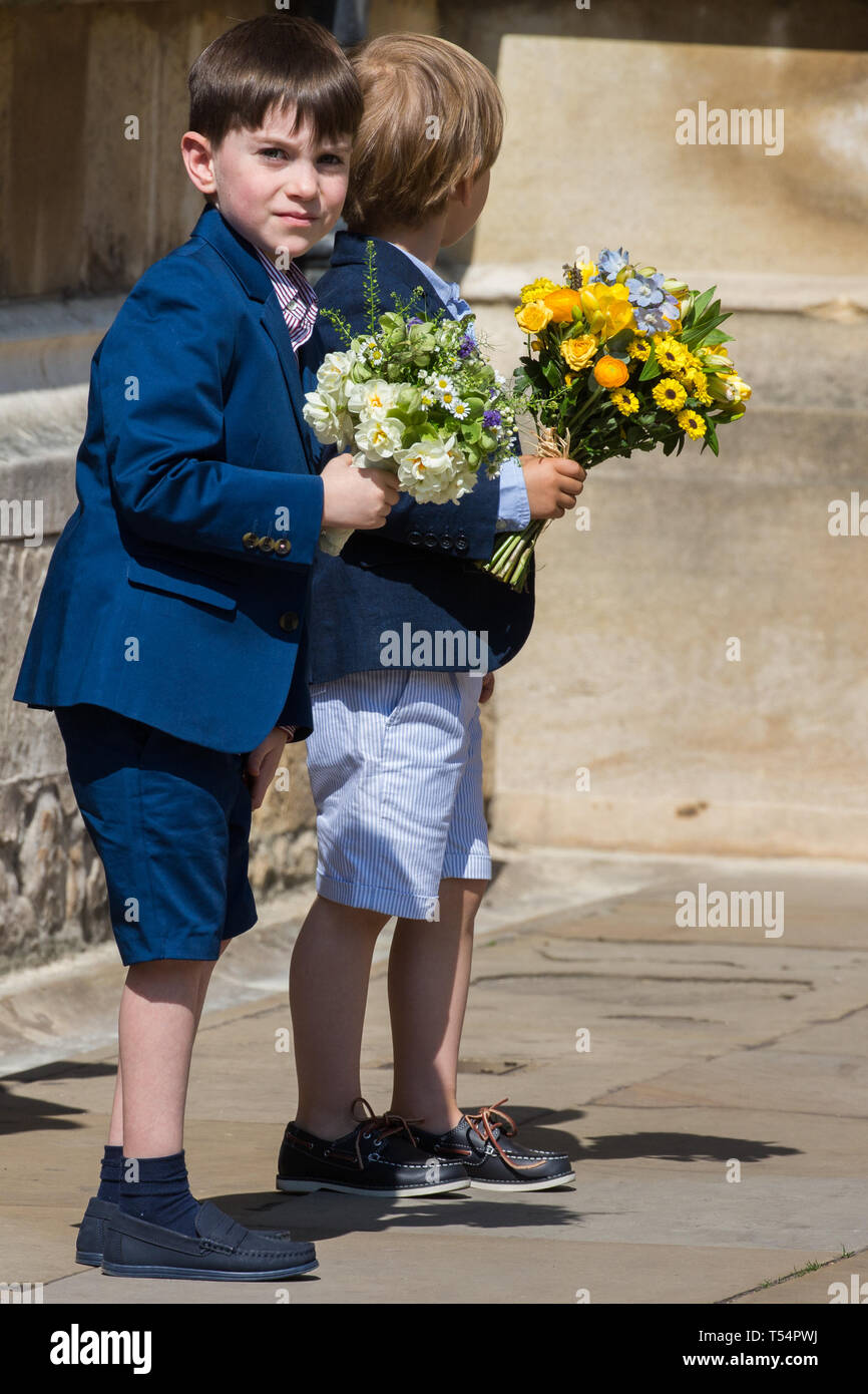 Windsor, UK. 21st April 2019. Two young boys wait to give traditional ...