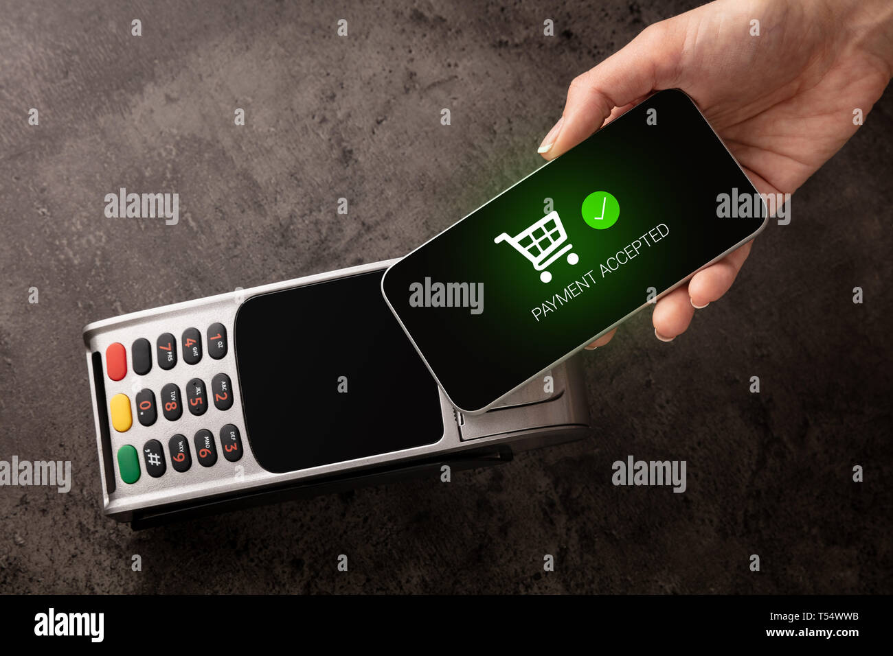 Mobile payment accepted on terminal Stock Photo - Alamy