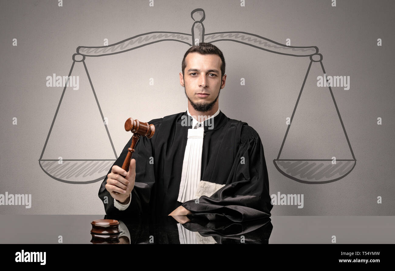 Young handsome judge in black gown making decision Stock Photo - Alamy