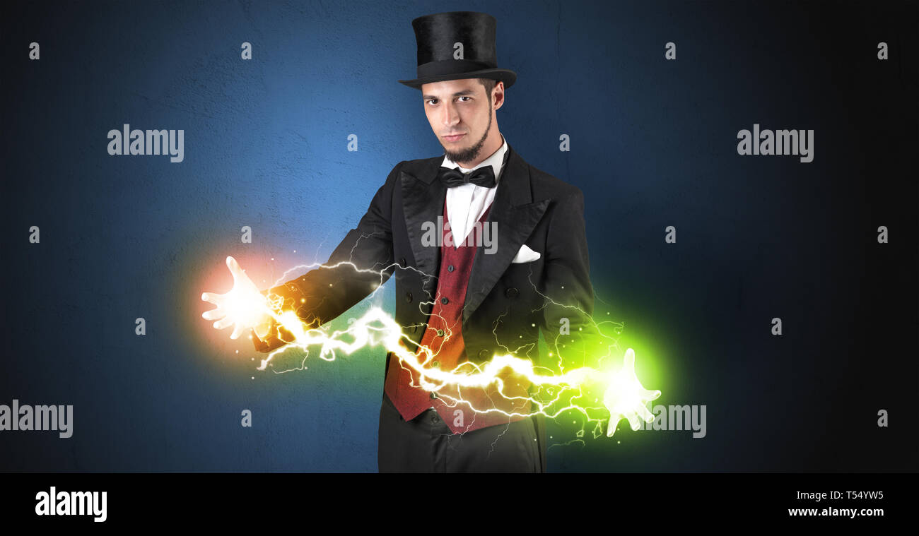 Magician sparkling super power between his two hands Stock Photo - Alamy