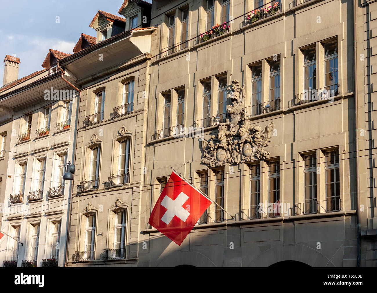 Switzerland flag hanging on building in Bern city Stock Photo - Alamy