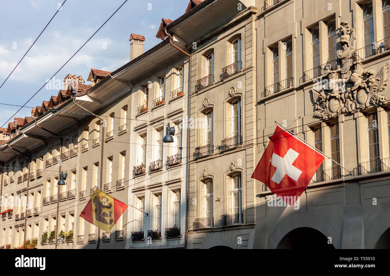 Switzerland flag hanging on building in Bern city Stock Photo - Alamy