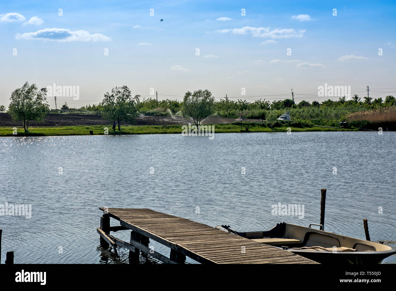 Picture of the lake at dusk and watering the field above the lake with ...