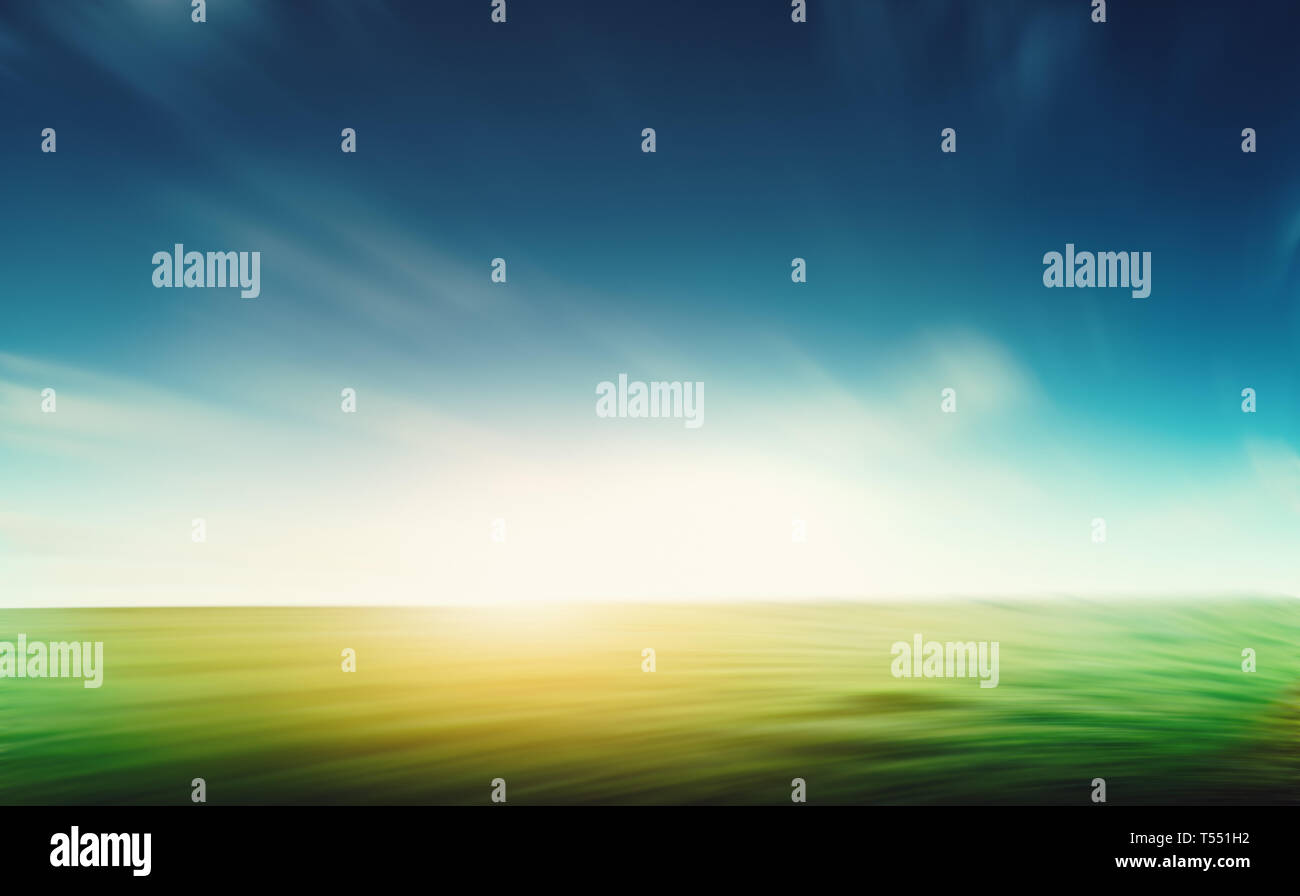 Grass and blue sky motion blur. Natural background Stock Photo - Alamy