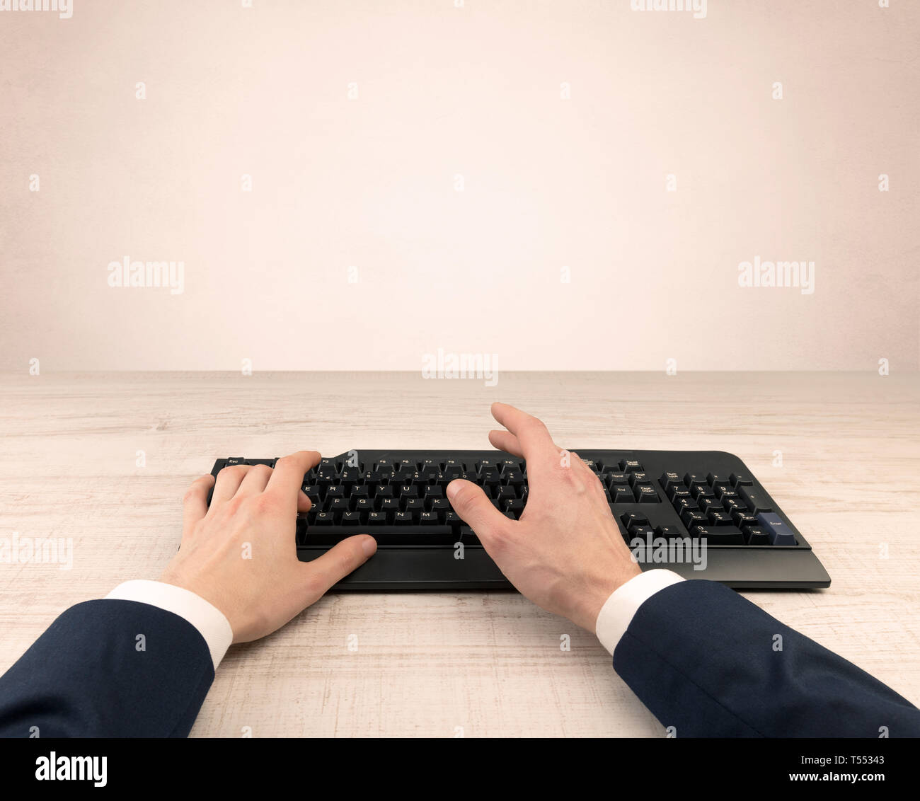 First person view of an elegant businessman hand typing on light ...