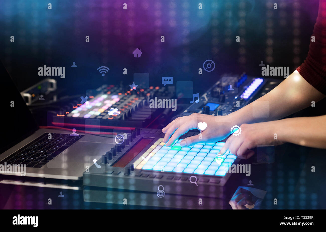 Hand mixing music on dj controller with social media concept icons ...