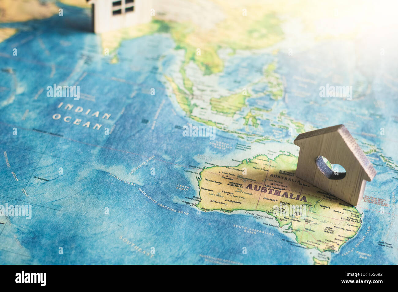 Wooden house on world map Stock Photo - Alamy