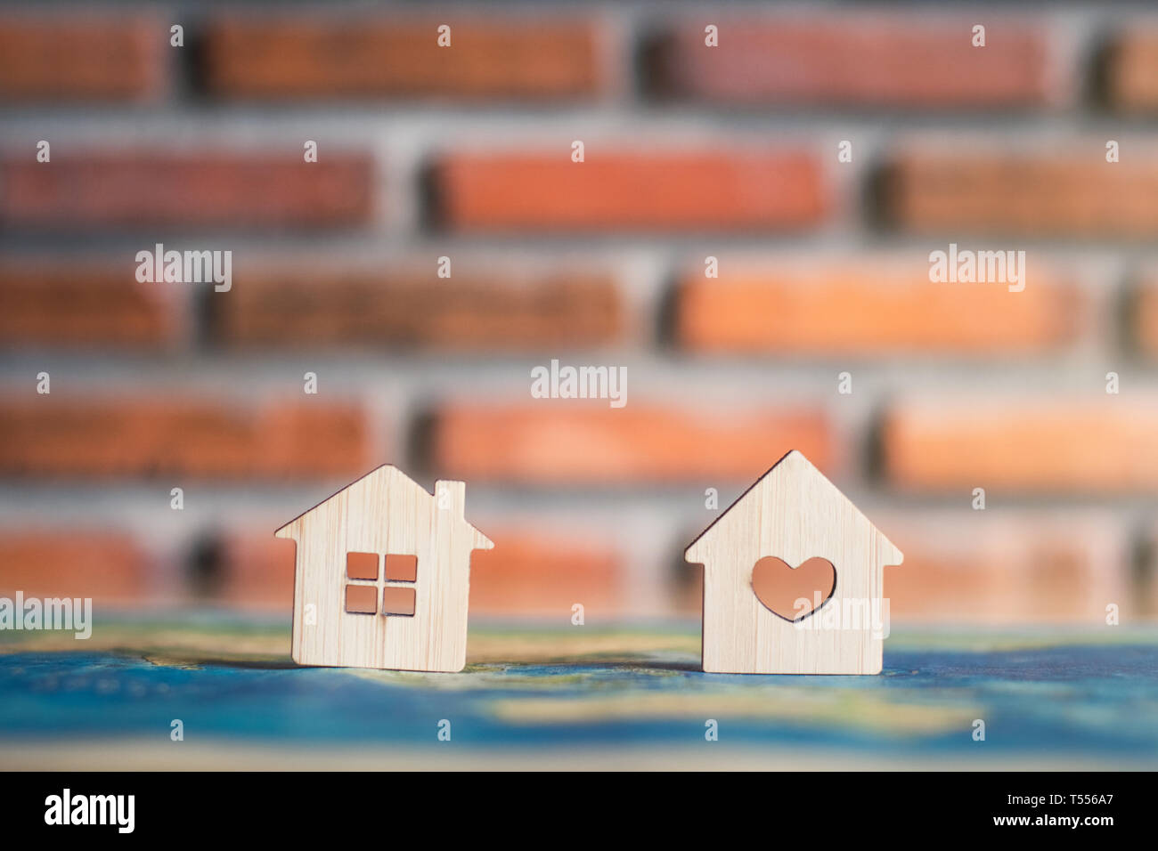 Wooden house on world map Stock Photo - Alamy