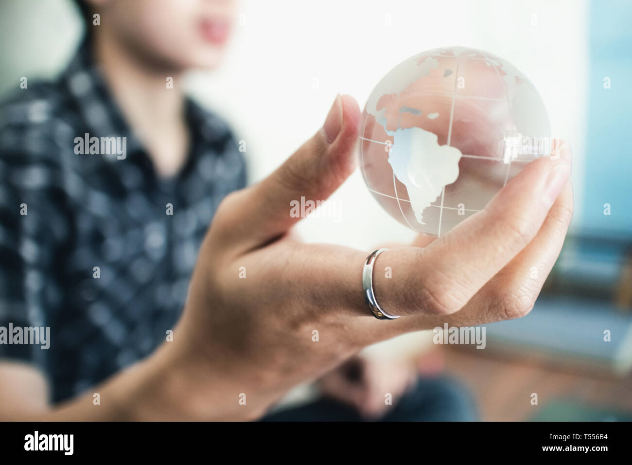 hand holding crystal world. business symbol Stock Photo - Alamy