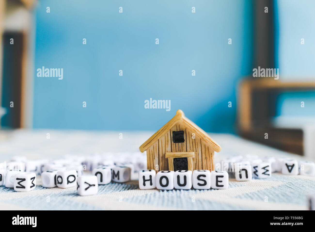 Miniature house model with "HOUSE" alphabet cube letter Stock Photo - Alamy