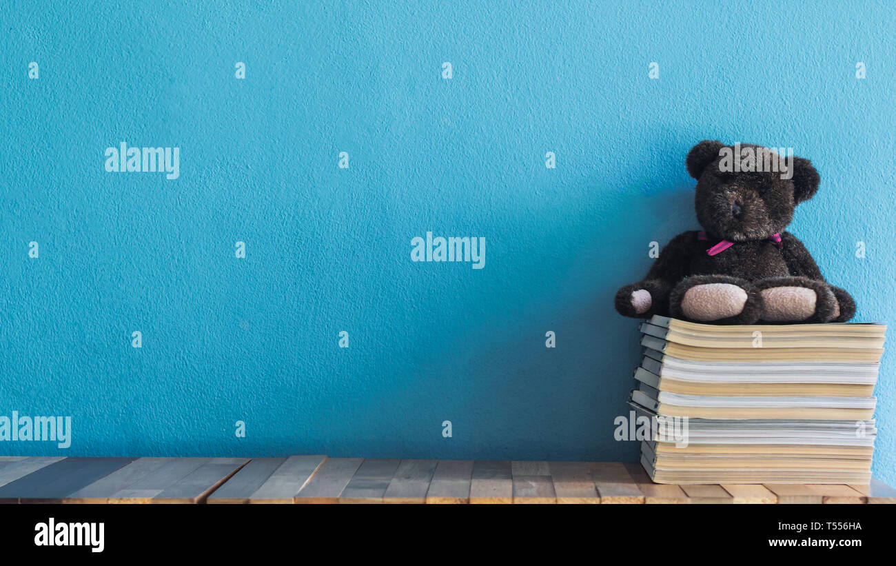 books on table top with blue wall Stock Photo - Alamy