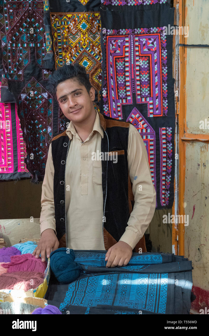 Young Man Selling Rugs And Wool At The Bazaar, Dust Mohammad near Zabol ...