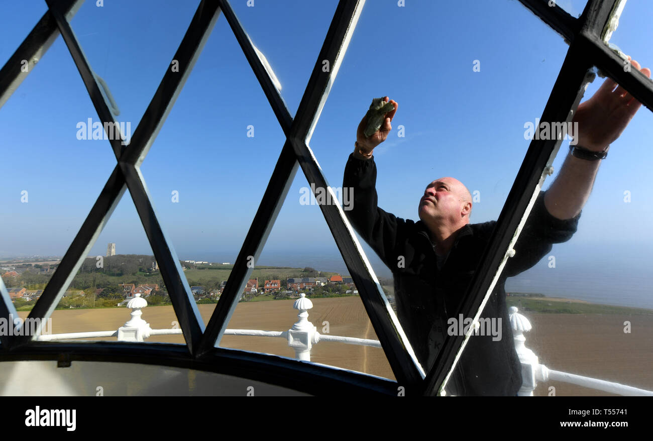 Lighthouse attendant Chris Moore cleans the glass on the outside of the ...
